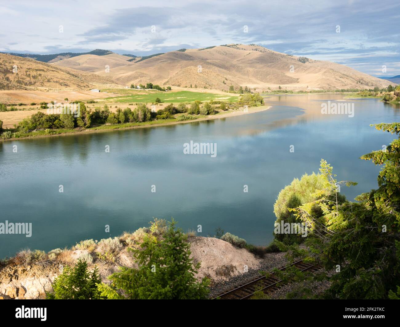 Railroad tracks running along scenic and wild Flathead river near Perma ...