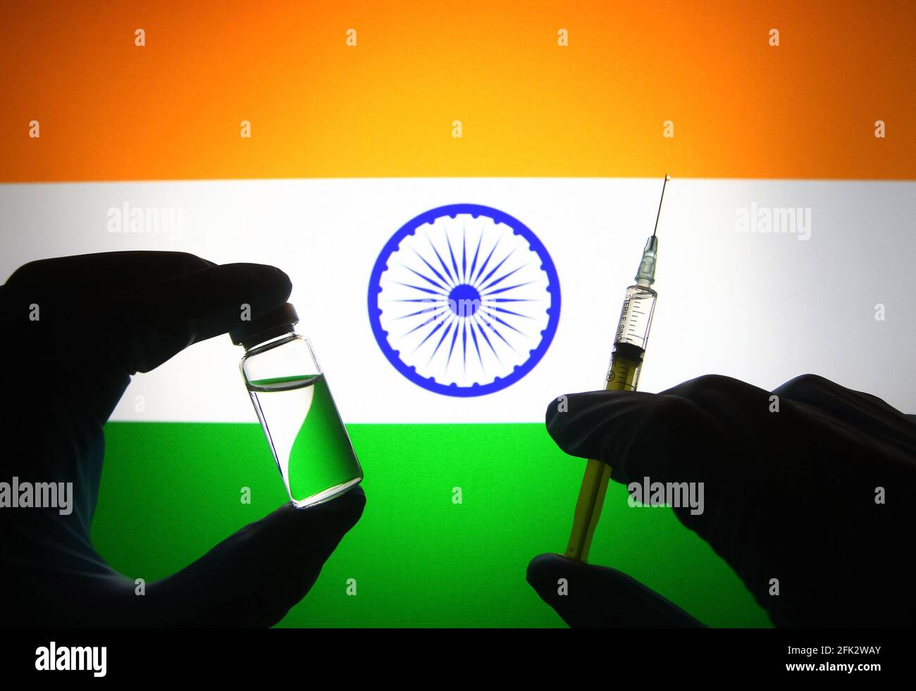 In this photo illustration a silhouette of hands in medical gloves hold ...