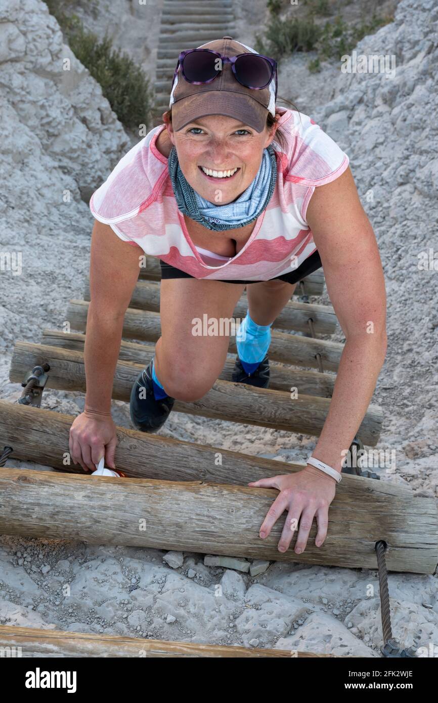 Woman Climbing Ladder in the Notch in Badlands National Park Stock ...