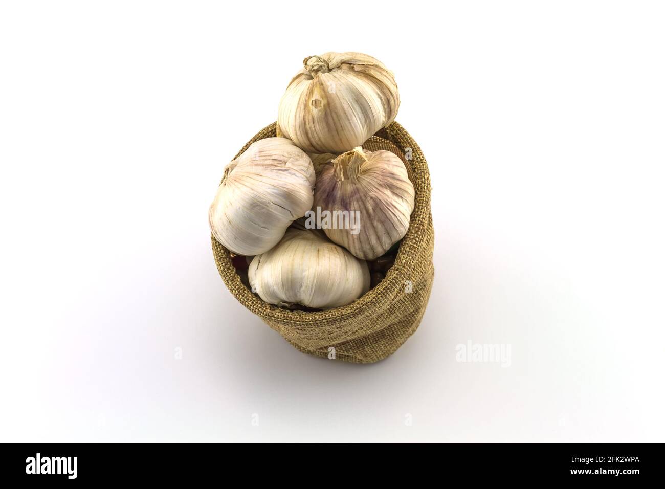 Close up dry garlic in sacks sisal isolated on white background on top ...