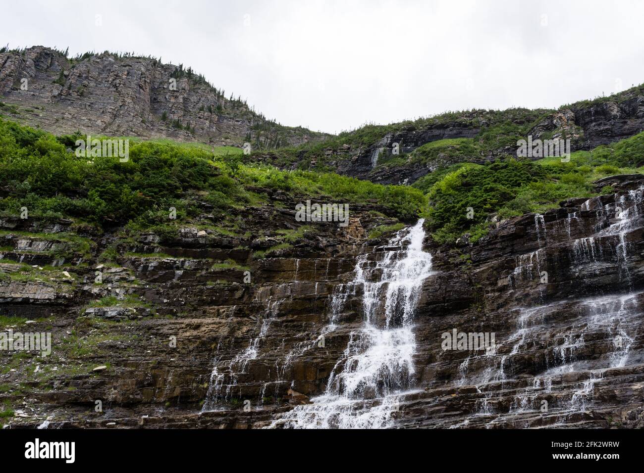 Weeping wall waterfall along Going-to-the-sun road in Glacier National ...