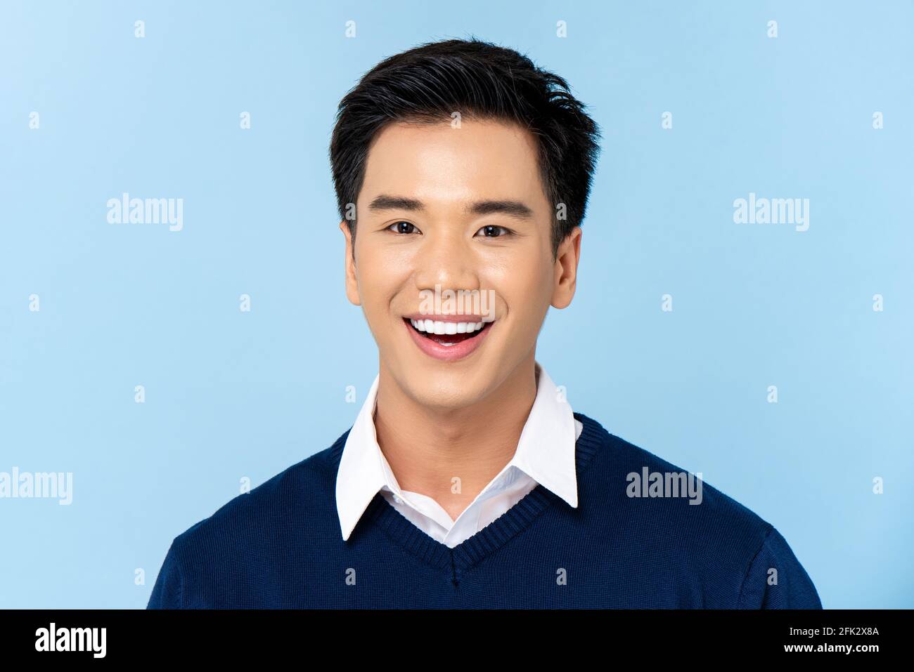 Close up portrait of young handsome smiling Asian man face on light ...