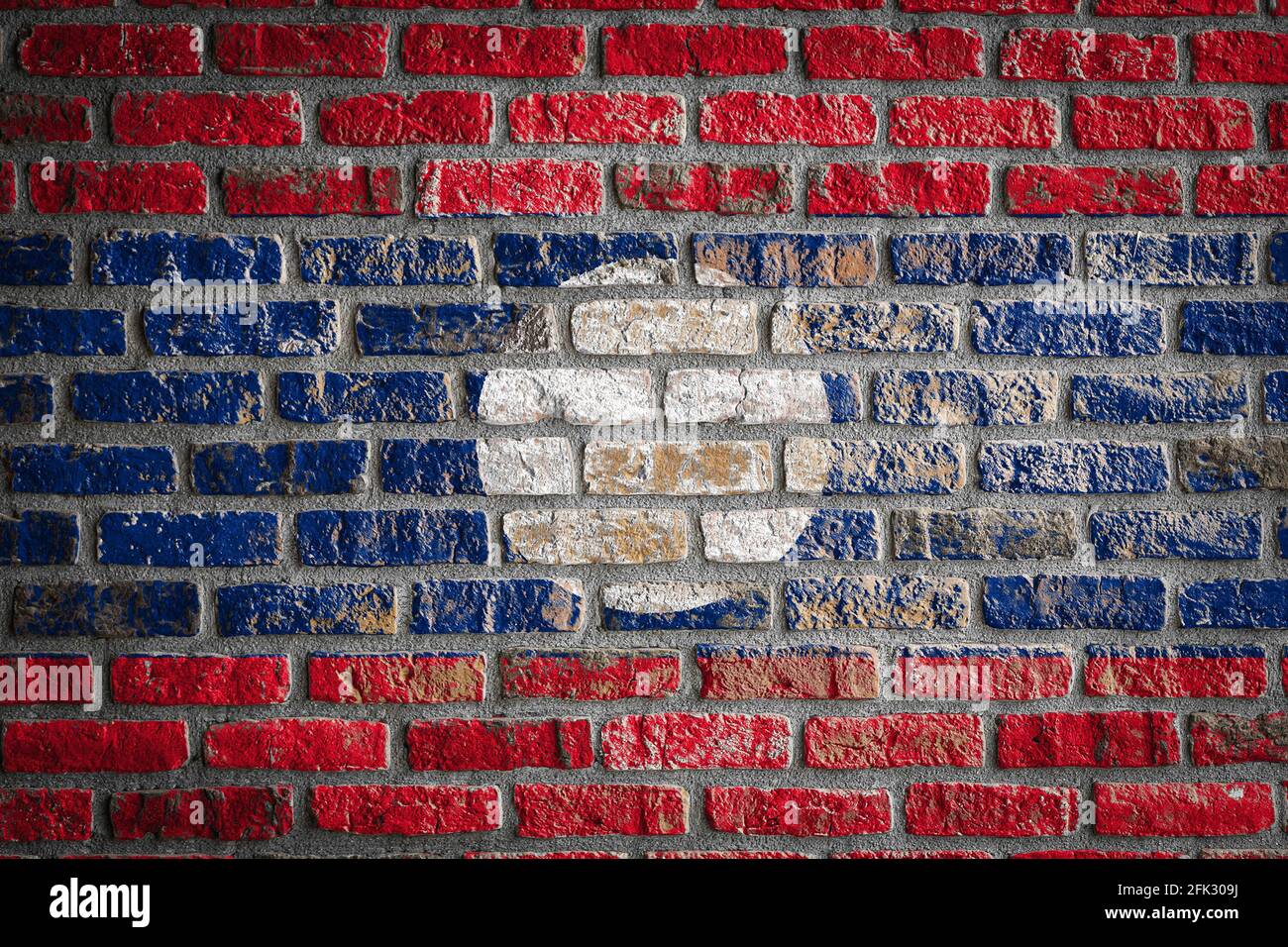 National flag of Laos depicting in paint colors on an old brick wall ...