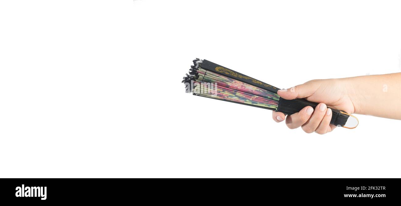 female hand holding closed fan on white background Stock Photo - Alamy