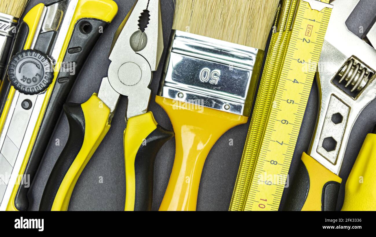 set of hand tools for home renovation on dark grey background. flat lay ...