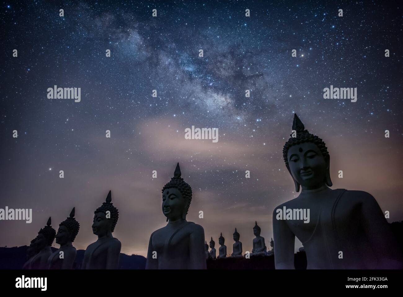 Milky way galaxy over many of buddha statues at Phu Phra Ban Mak Khaeng ...