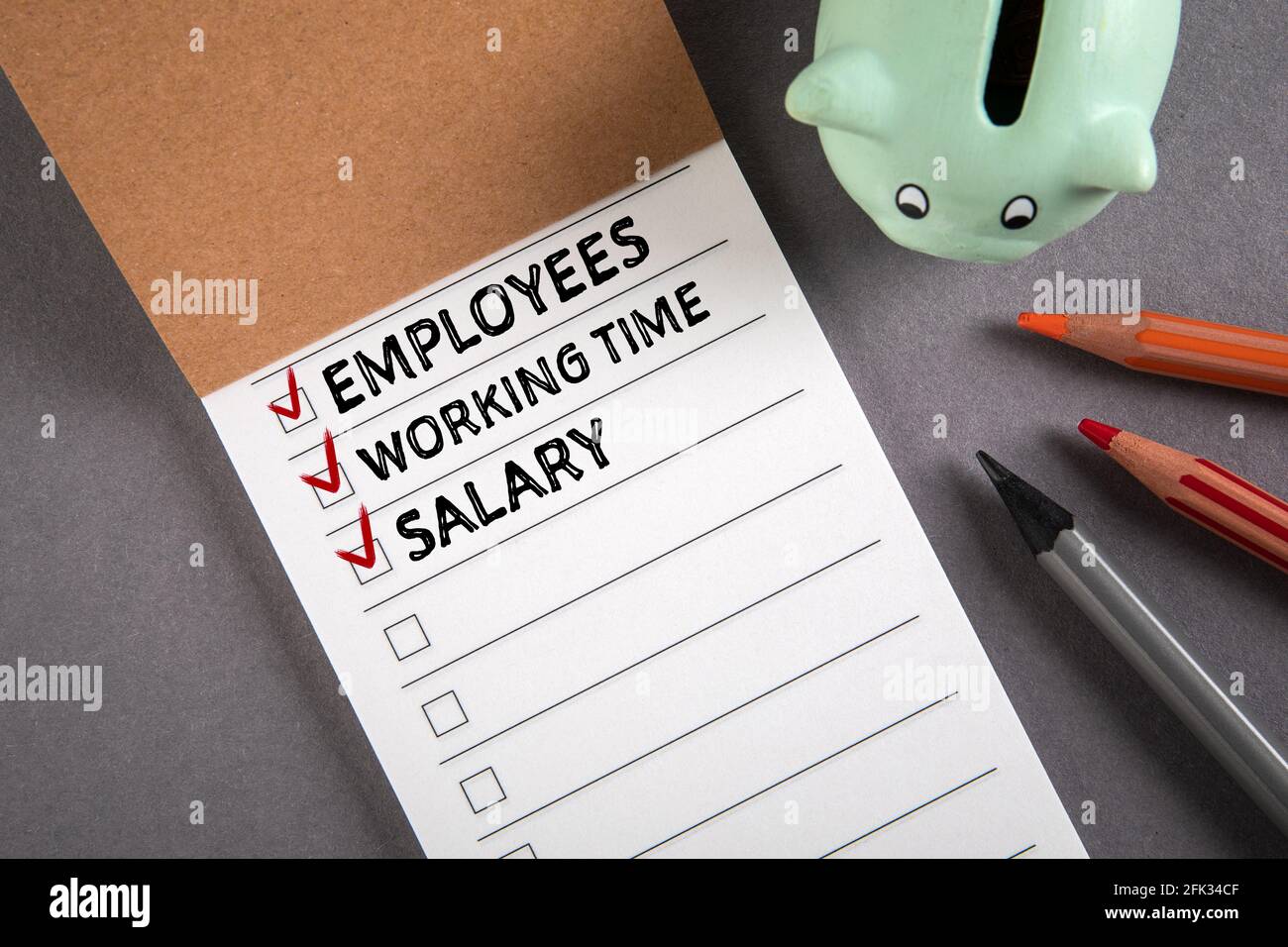 Payroll concept. Salary, employees and working time. Notebook on gray ...