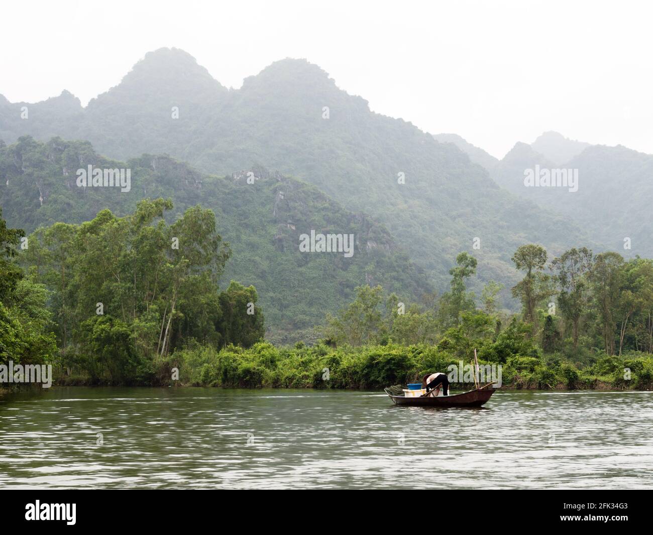 Limestone peaks around Yen river on the way to Perfume Pagoda, a ...