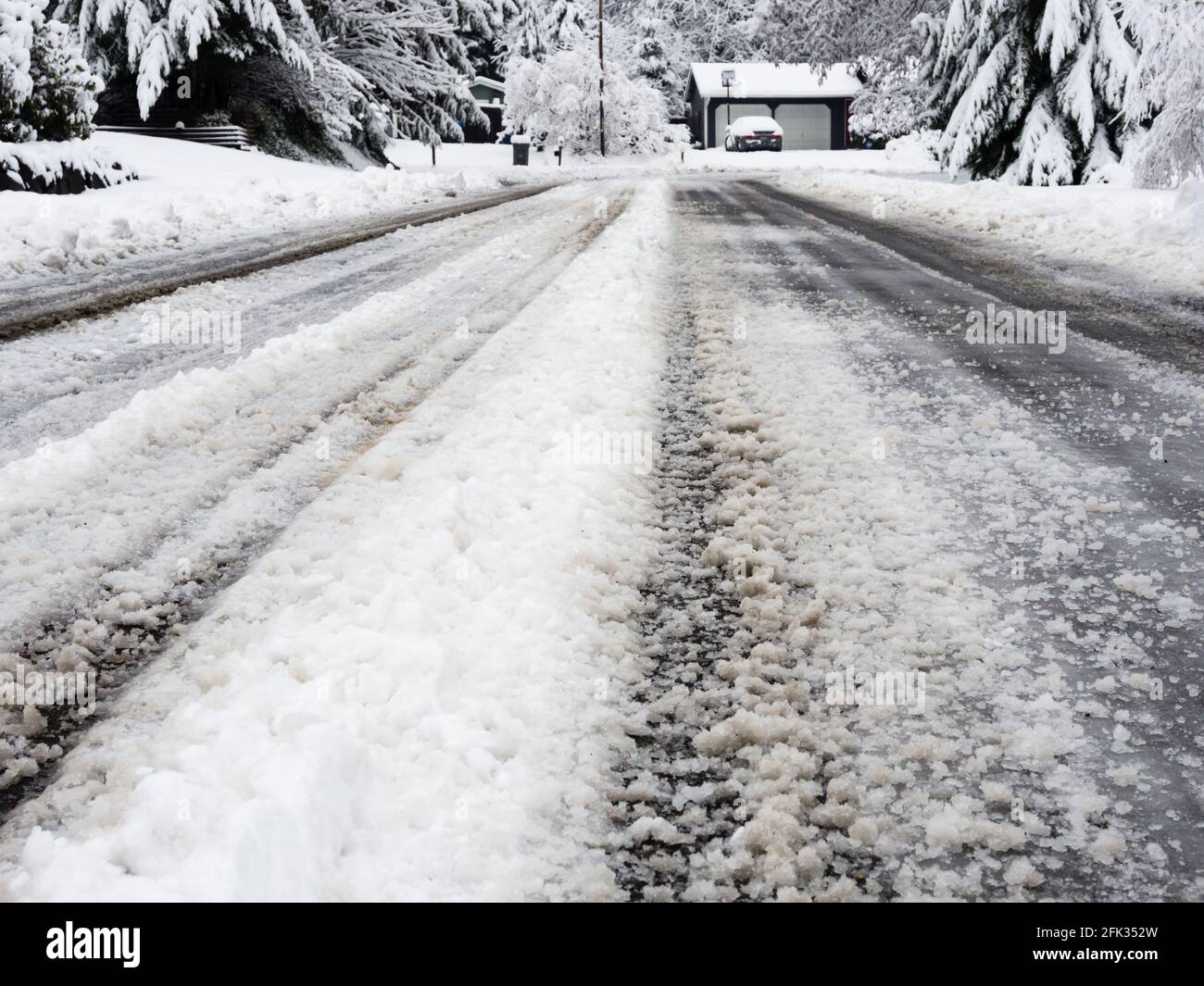 Snow covered road in residential district Stock Photo - Alamy