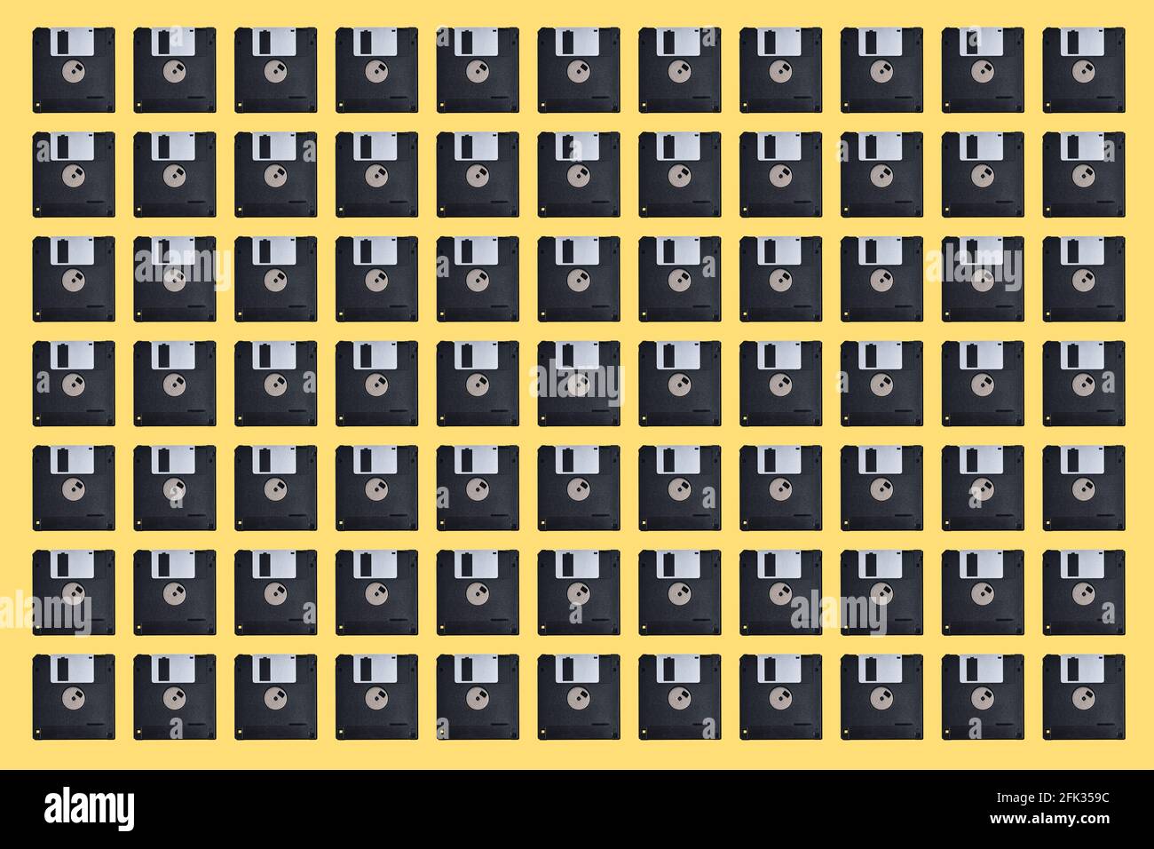 Pattern with many floppy disks on yellow background. Retro computer ...