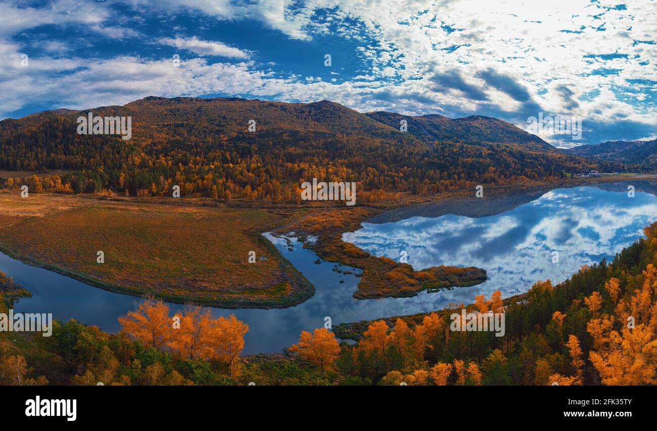 Aerial view of road and lake in beautiful autumn Altai forest ...