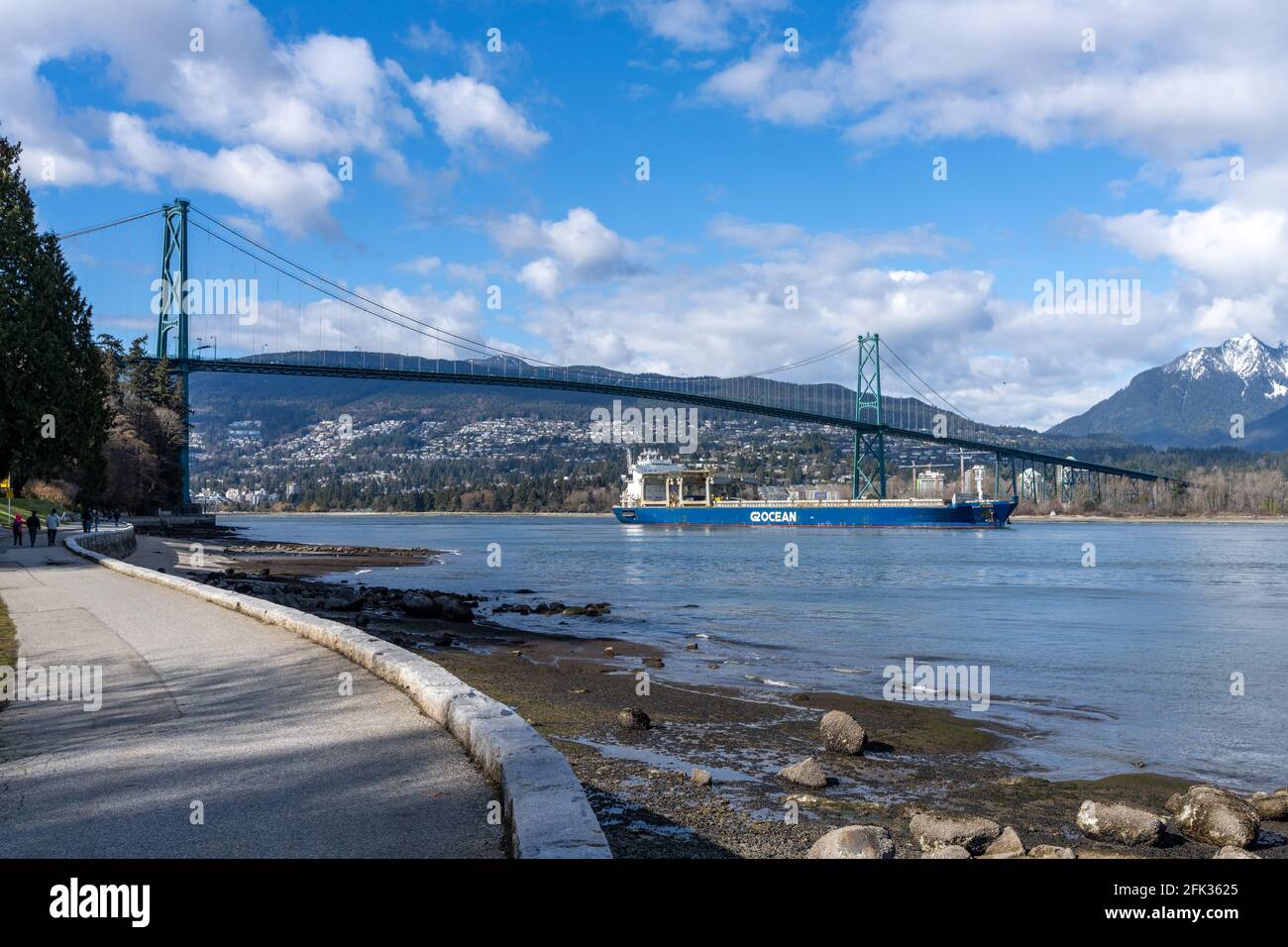 Stanley Park Seawall in sunny day. Lions Gate Bridge in the background ...