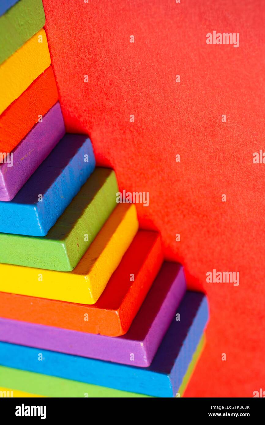 Colorful dominoes. Rainbow colored chain reaction Stock Photo - Alamy