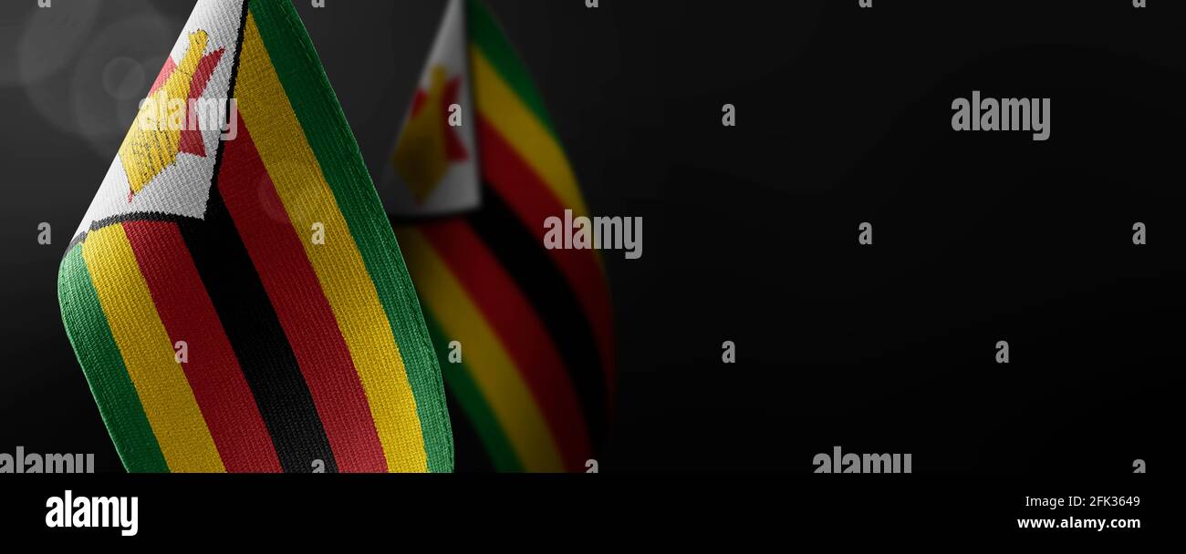 Small national flags of the Zimbabwe on a dark background Stock Photo ...