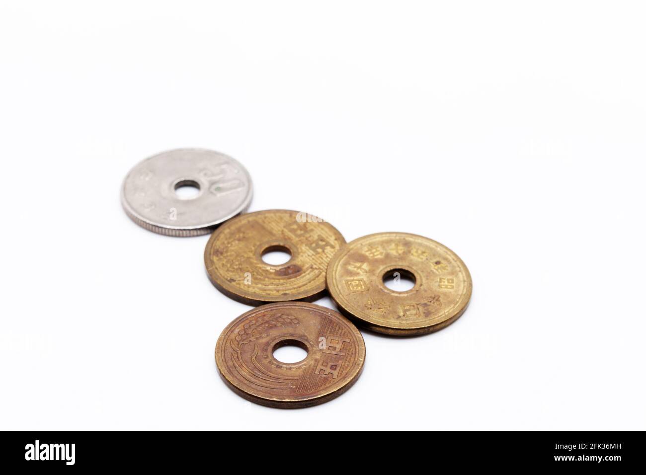 four Chinese coins with holes in the middle on a white background Stock ...