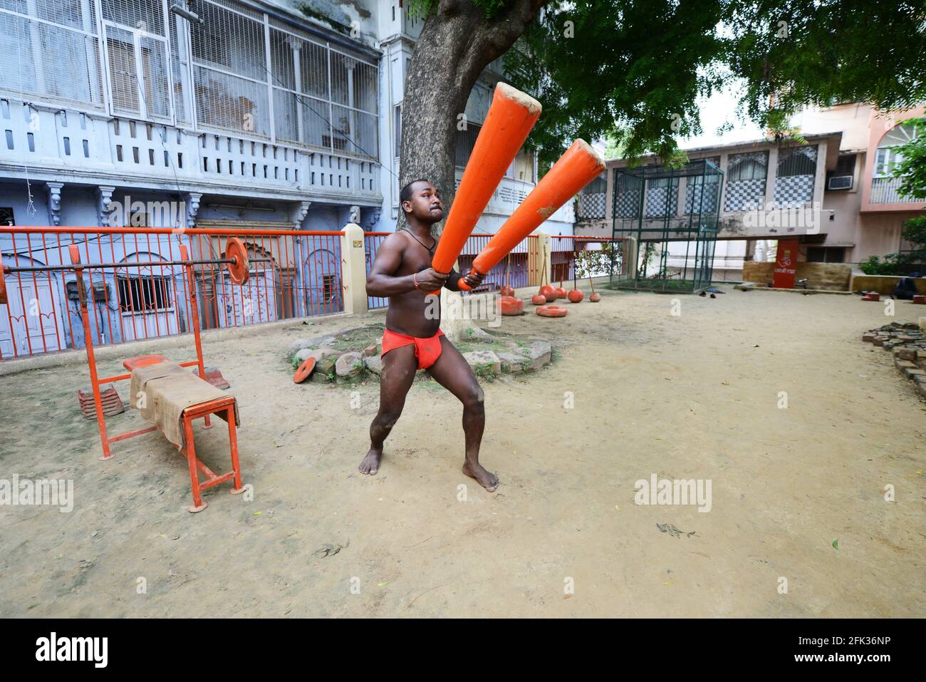 An Indian pehlwan exercising with Indian clubs in Varansai, Uttar ...
