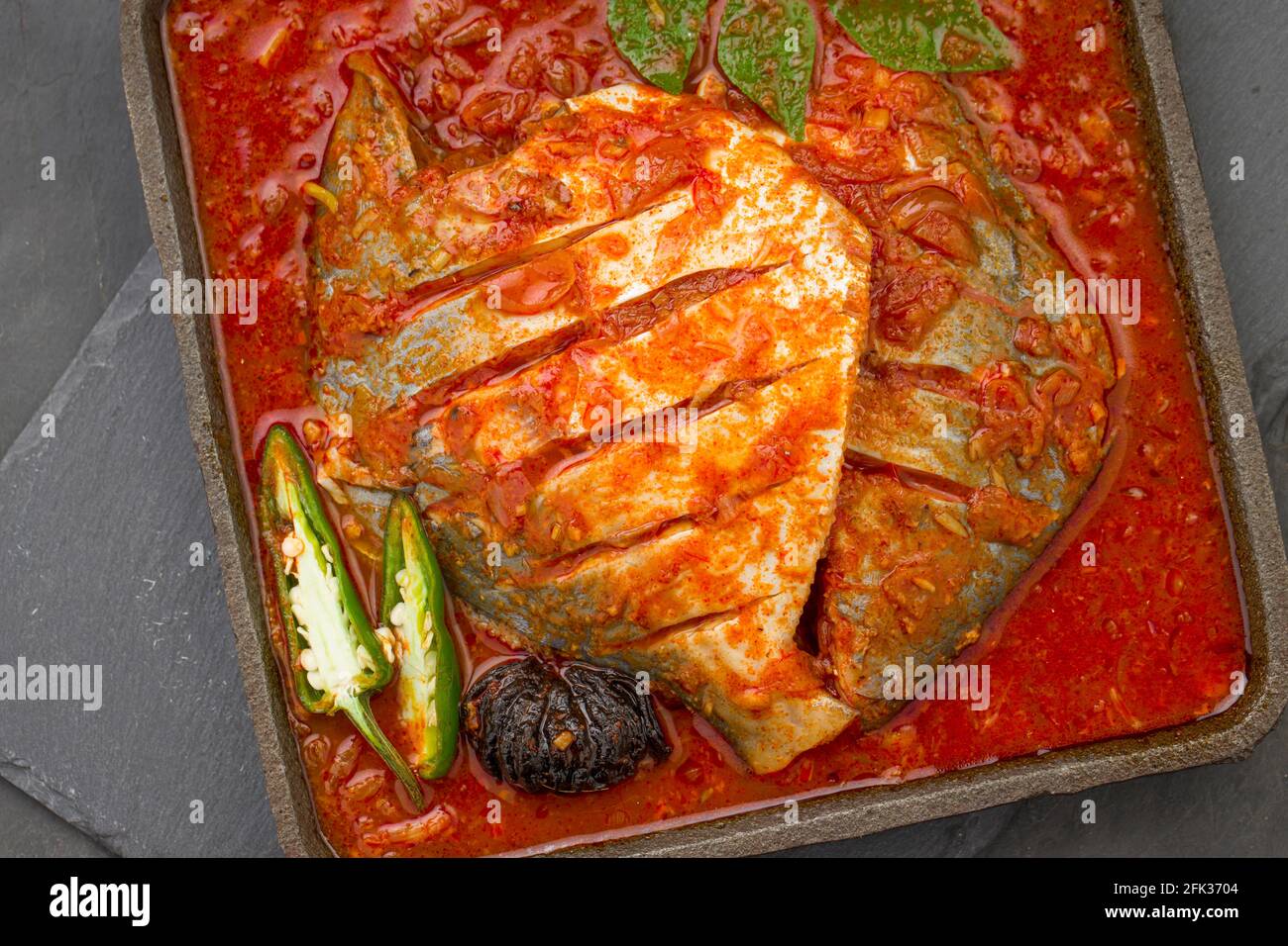 White pomfret masala curry , made in south indian style with thick red ...