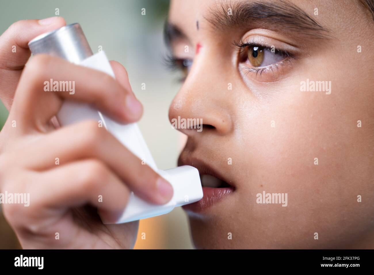 Close up head shot of Kid using Asthma medication inhaler - Concept of ...