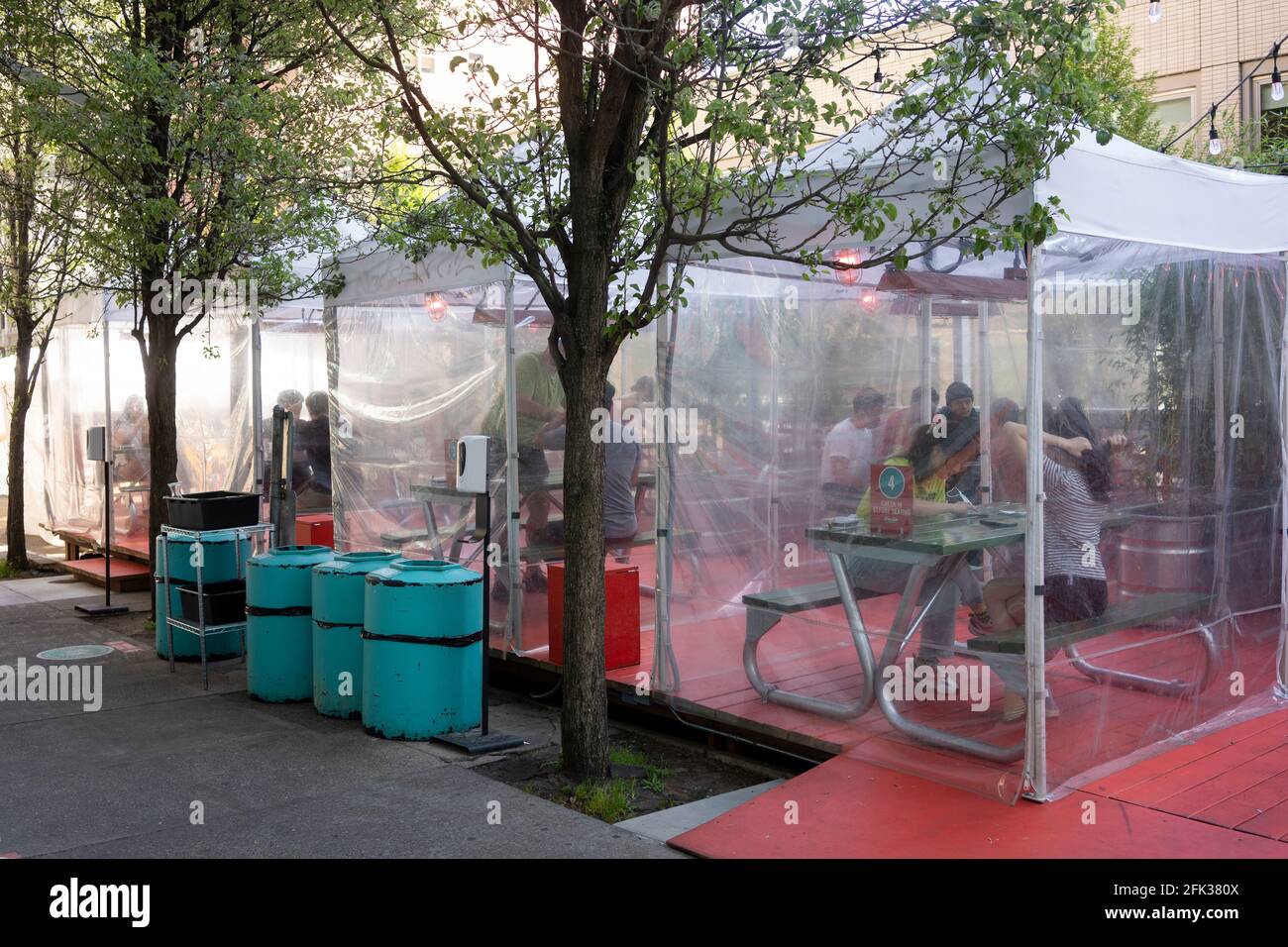 Restaurant goers in the outdoor dining tents outside of the Luc Lac ...