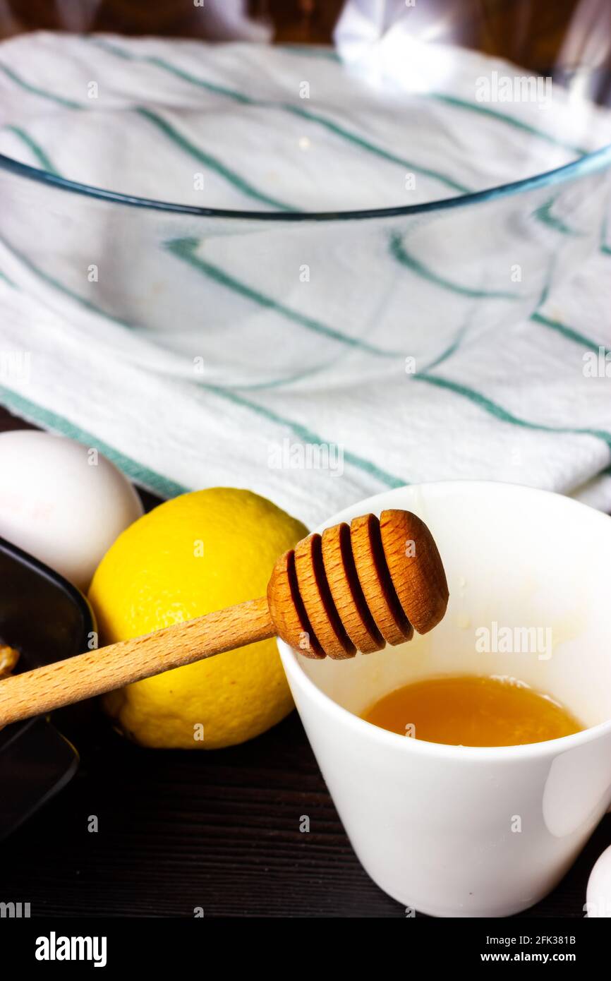 Honey in a cup and honey spoon. Products for baking Stock Photo - Alamy