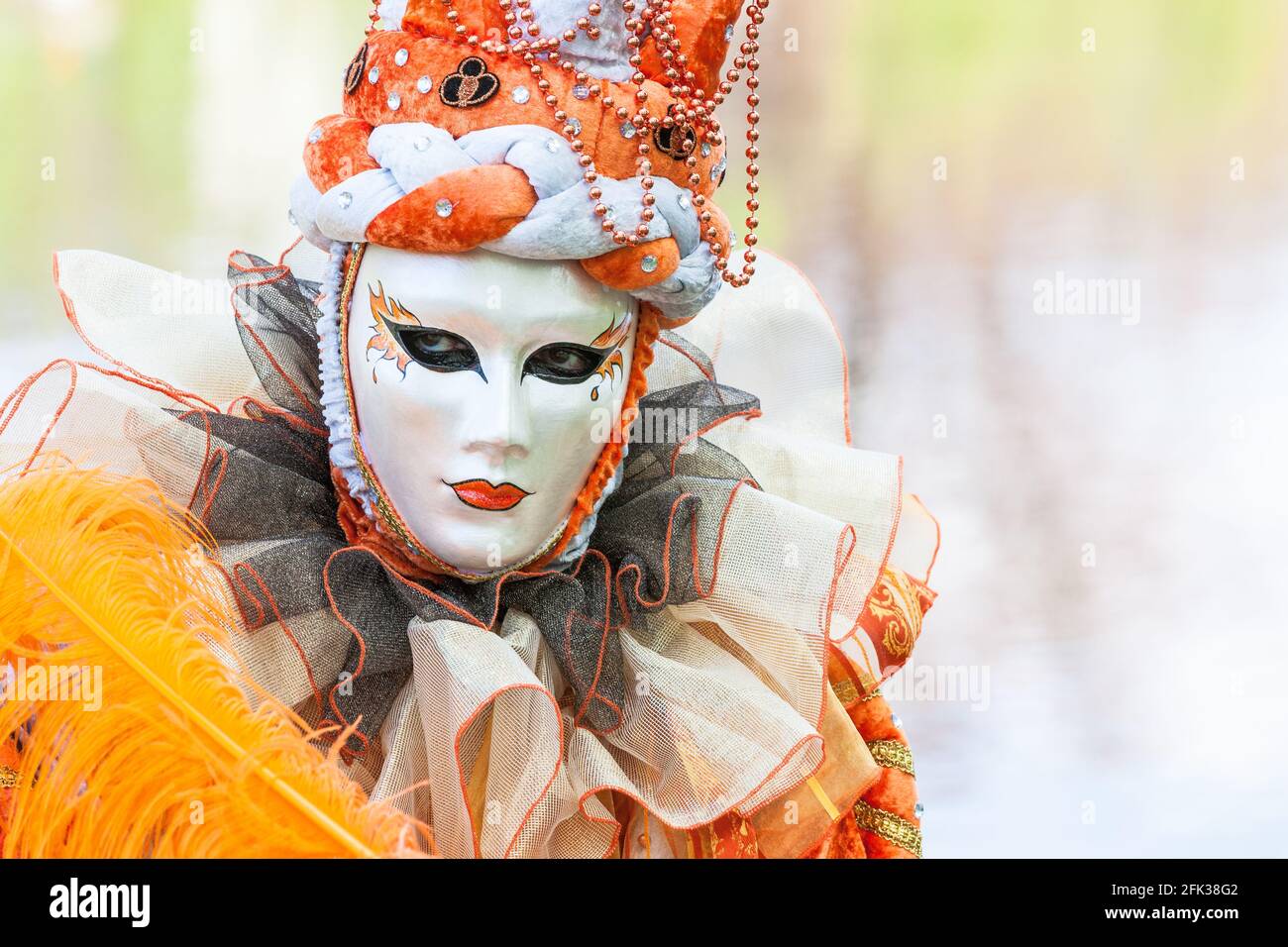 Venetian mask with dominant orange Stock Photo - Alamy
