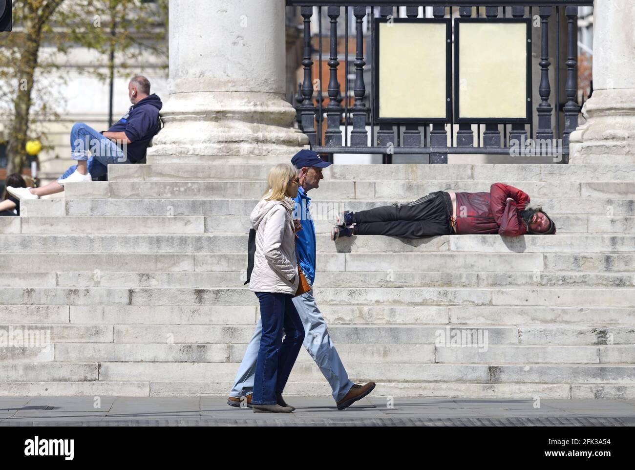 London, England, UK. Man asleep on the steps of St Martin In The Fields ...