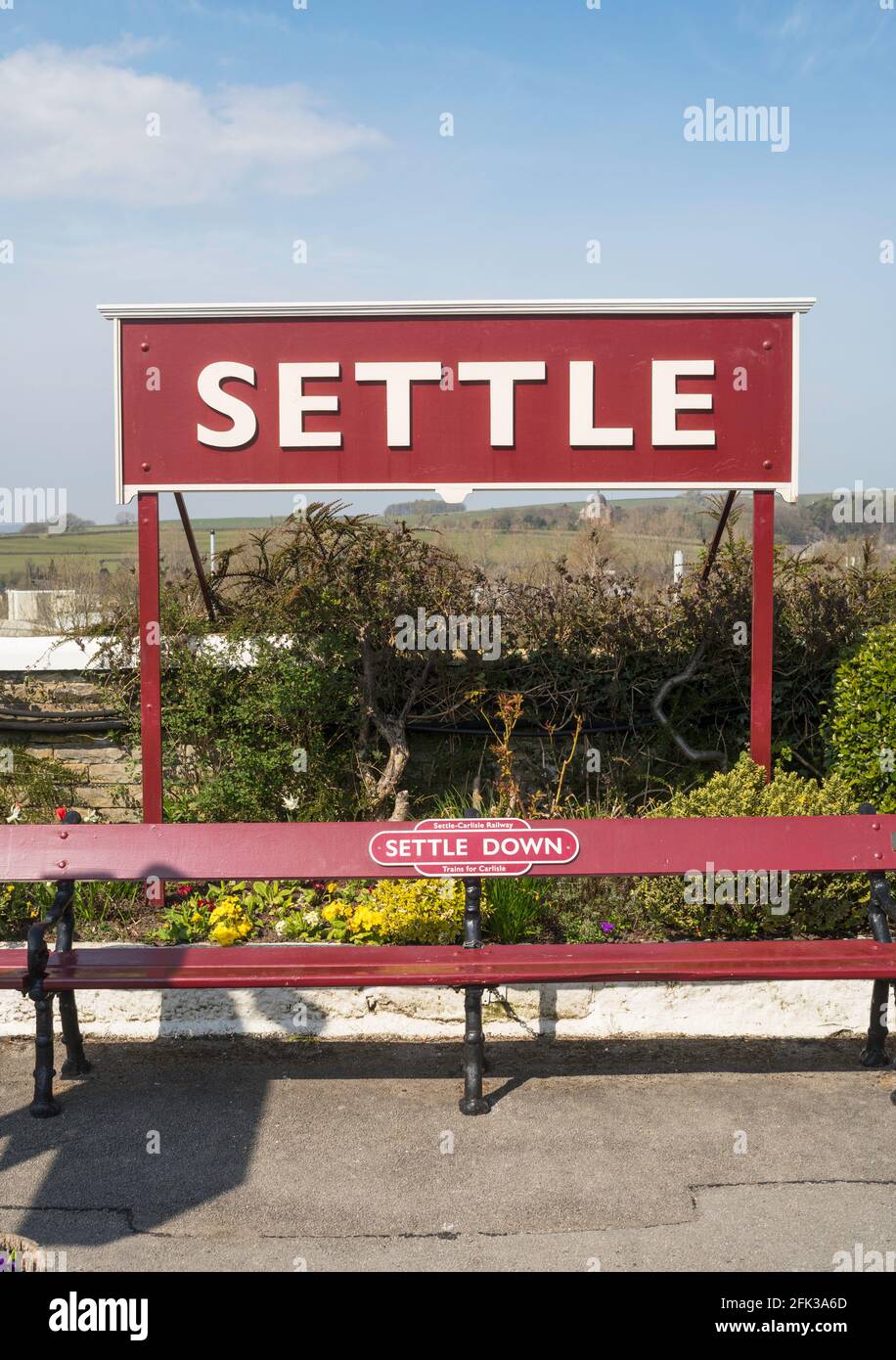 Settle railway station name sign and Settle Down seat in Yorkshire ...