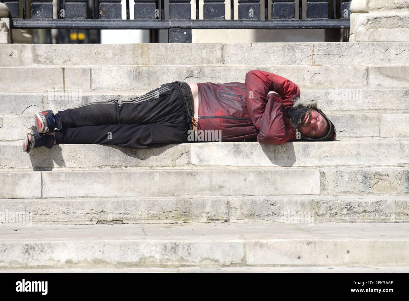 London, England, UK. Man asleep on the steps of St Martin In The Fields ...