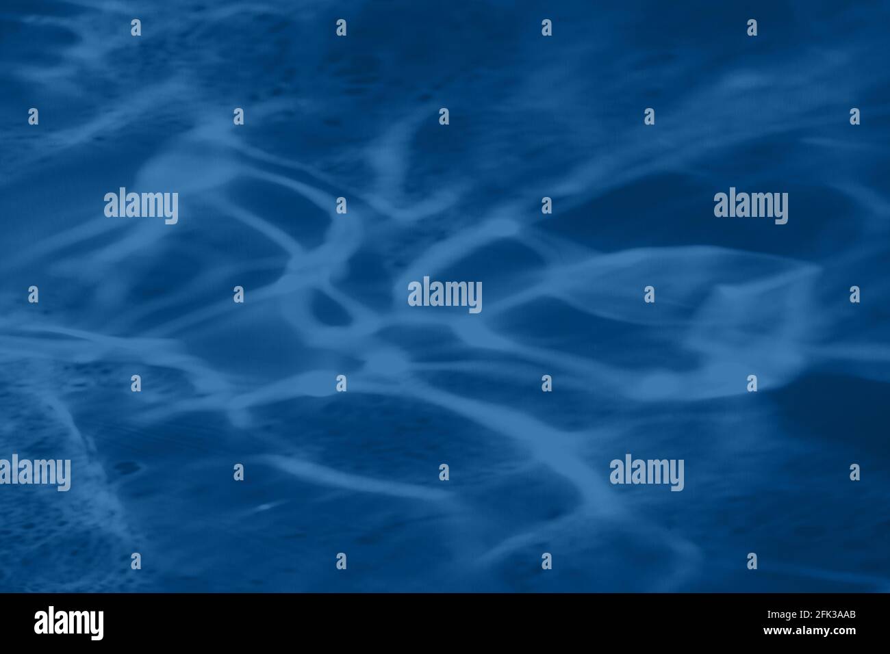 blue colored abstract background with light and shadows caustic effect ...