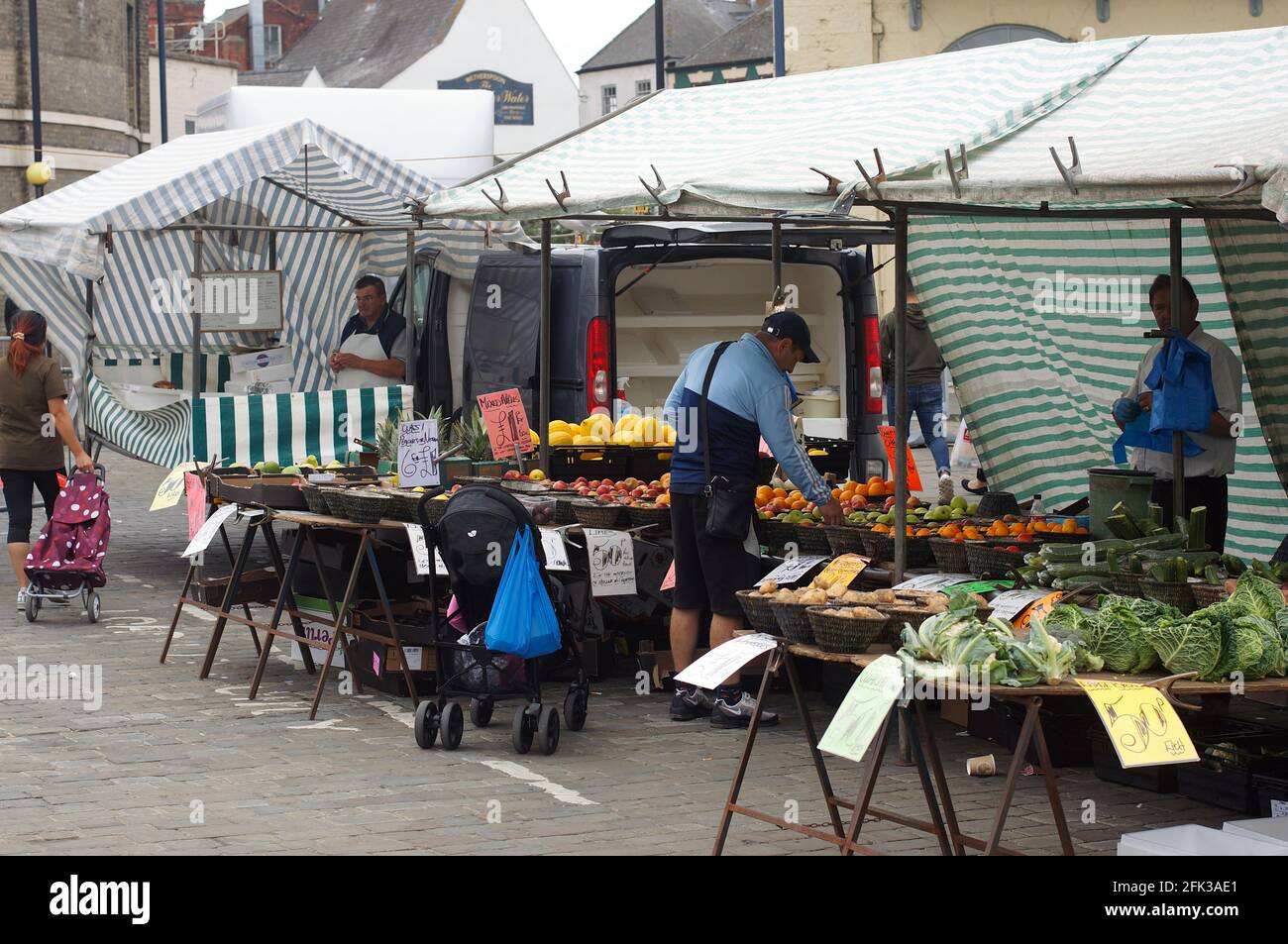 People buying fruit and vegetables at market stall hi-res stock ...