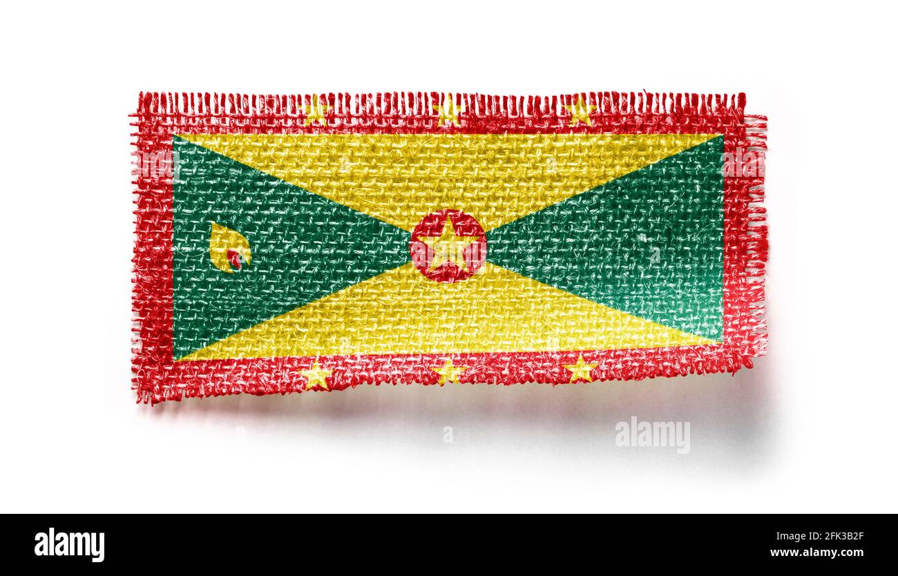 Grenada flag on a piece of cloth on a white background Stock Photo - Alamy