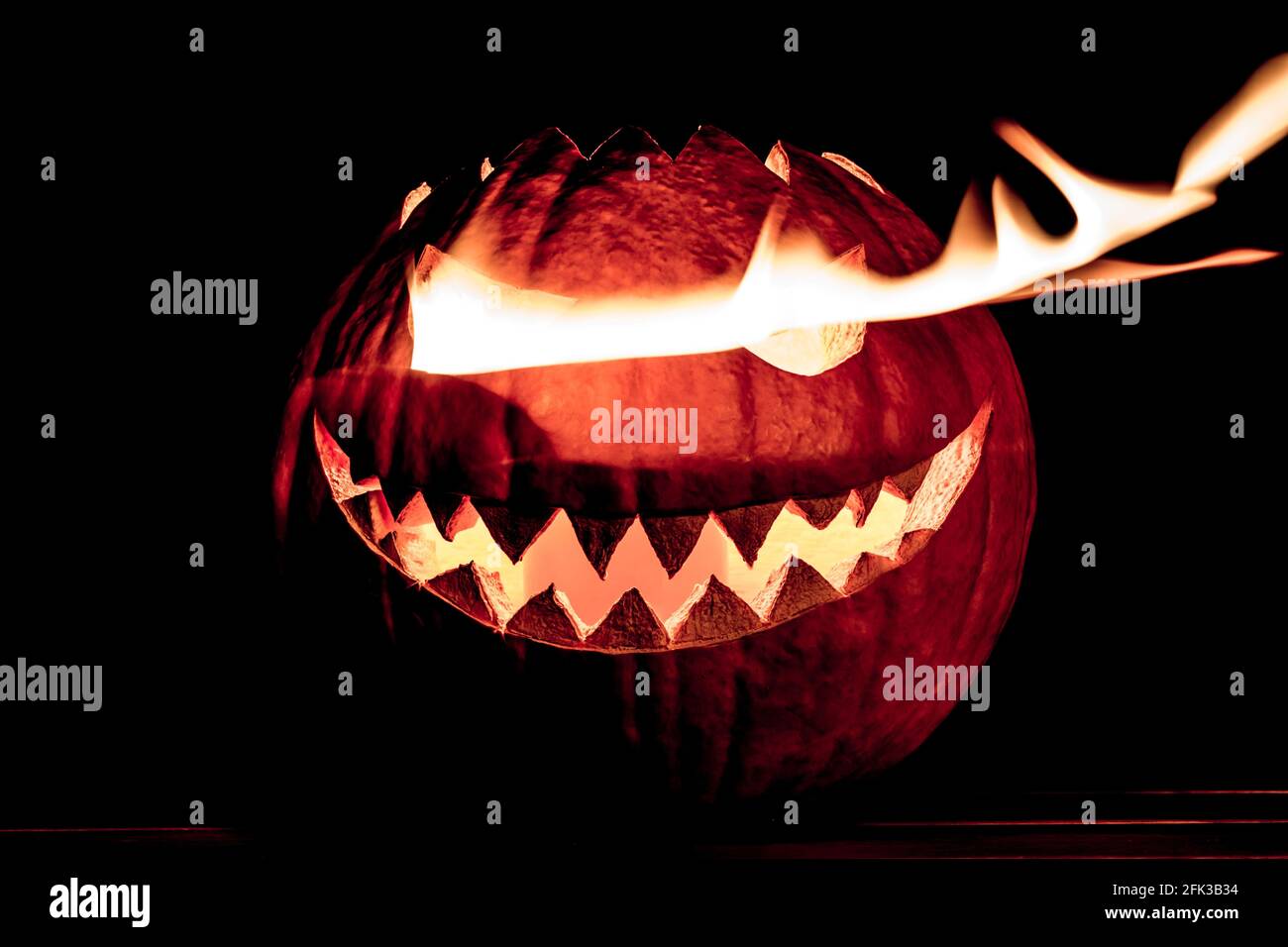 Carved spooky halloween pumpkin with glowing hot fire flame eyes. Big ...