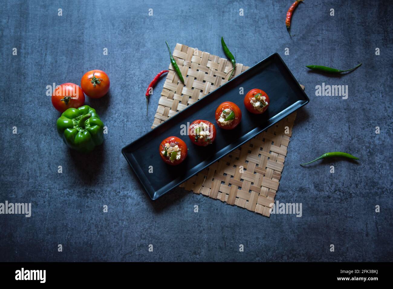 Stuffed tomatoes, an Indian starter prepared in white oil with ...