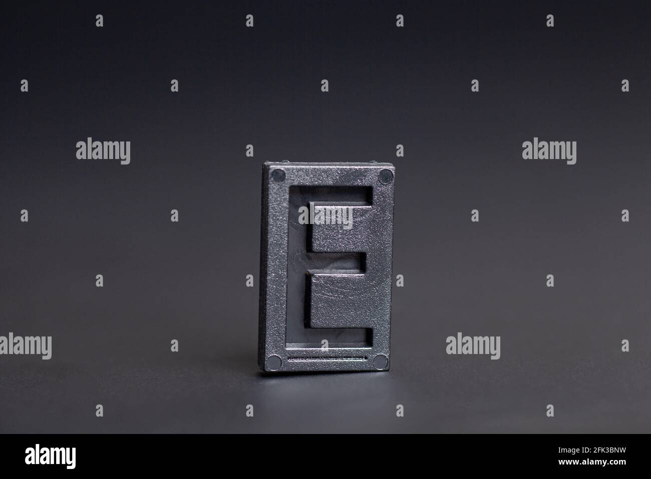 Letter Press E on black background Stock Photo - Alamy