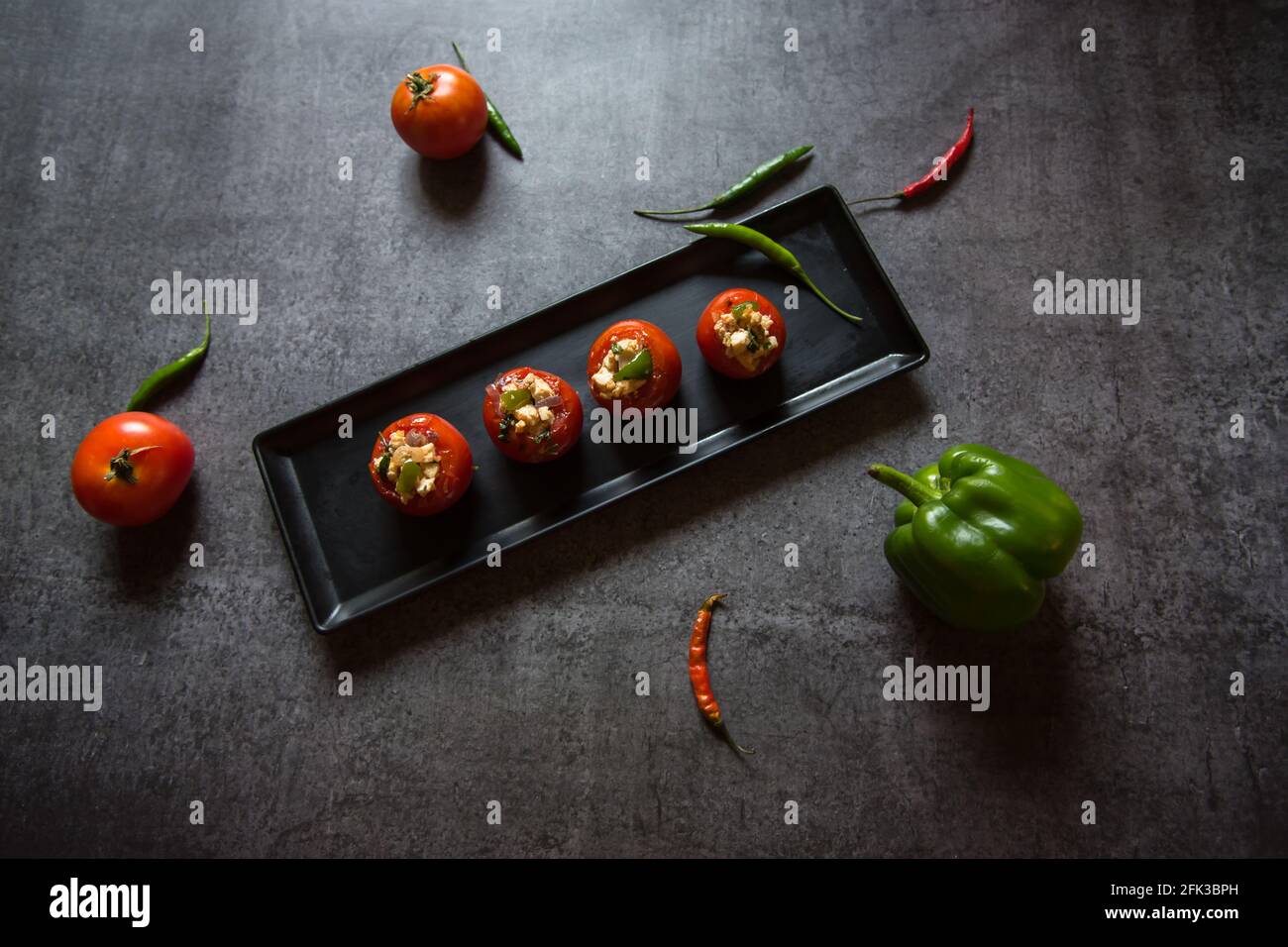 Stuffed tomatoes, an Indian starter prepared in white oil with ...