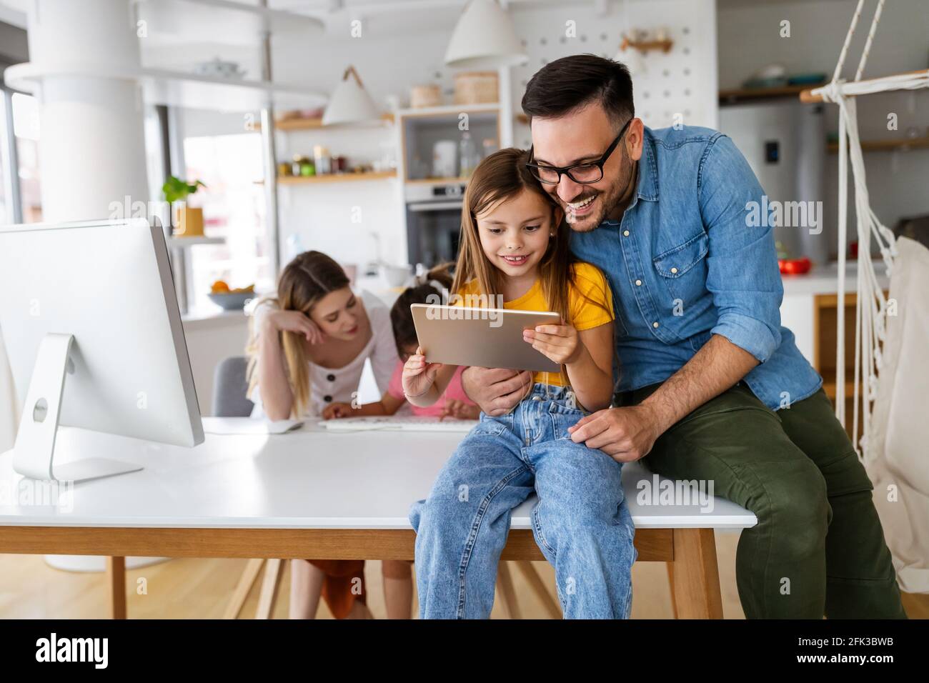 Online school, technology, family concept. Happy parents helping to ...