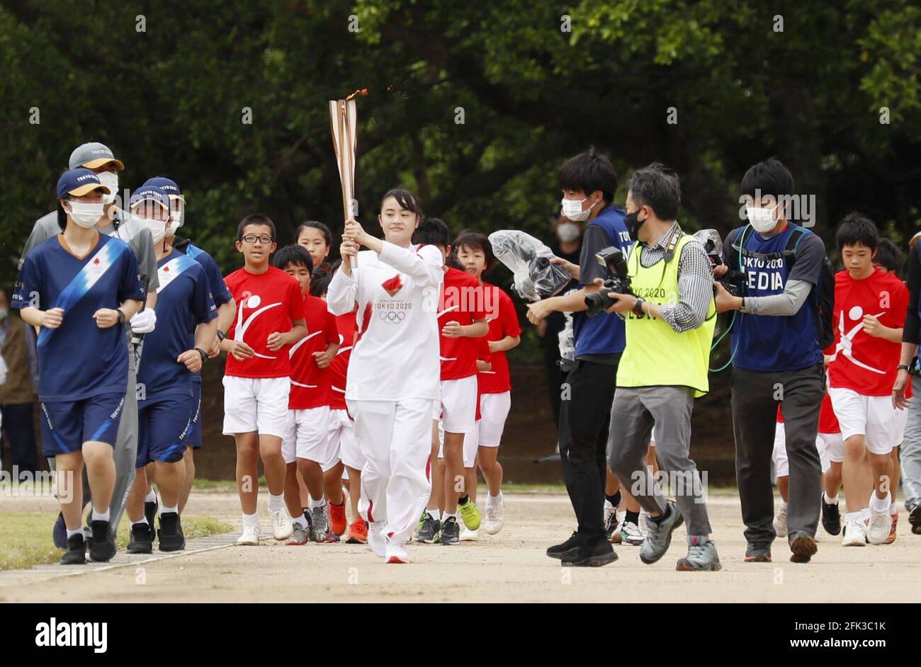 Tokyo, Japan, April 28, 2021. A Tokyo Olympic torch relay participant ...