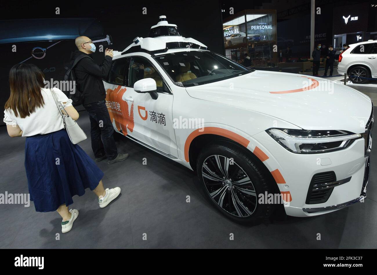 SHANGHAI, CHINA - APRIL 19, 2021 - Visitors look at Didi's new ...