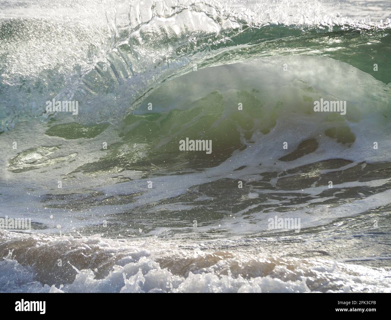Clear water surf, closeup ocean waves, glass like curled edge of a tube ...