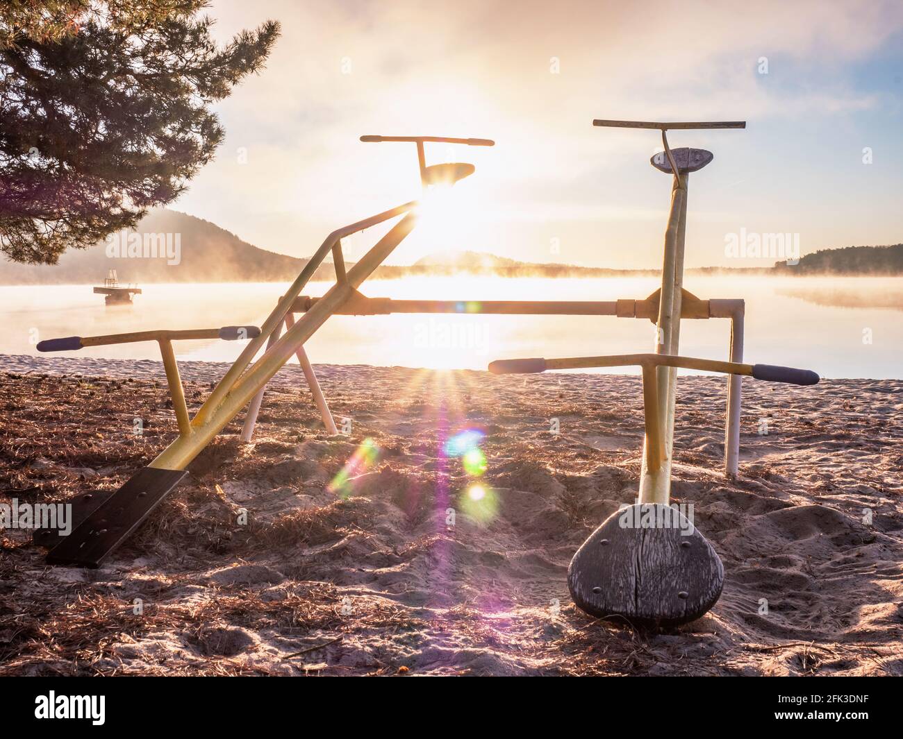Swing or teeterboard on playground outdoors. Childhood, equipment and ...