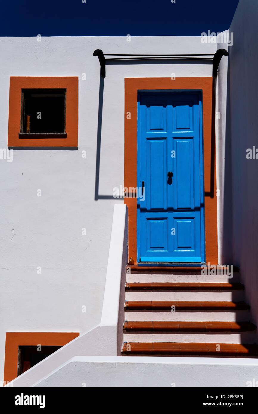 Blue door of a white resort town building with orange frames Stock ...