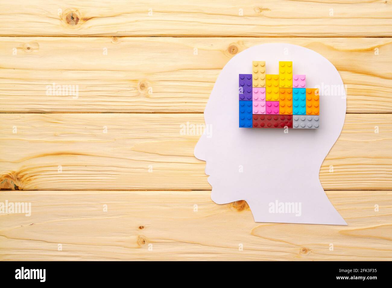 Papercut silhouette of human head with colorful constructor pieces ...
