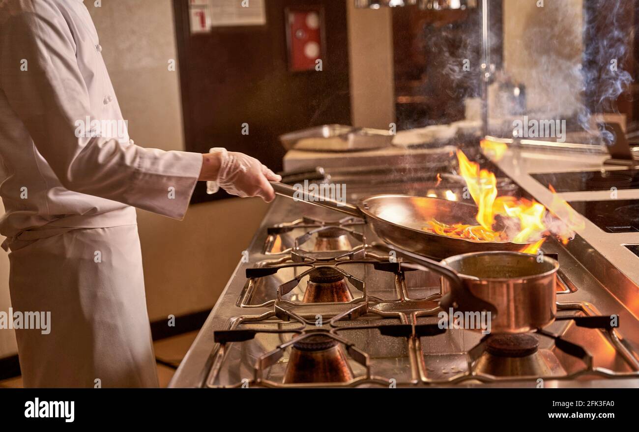 Fire burning inside a pan with peppers Stock Photo - Alamy