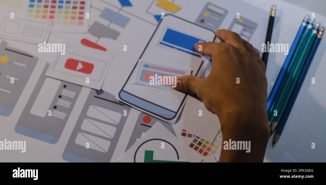 Designers drawing mobile ux app development concept. Man hold pencil ...
