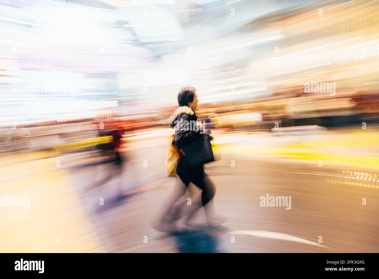 Tokyo, Japan - December 13, 2015: Abstract image of woman rushing at ...