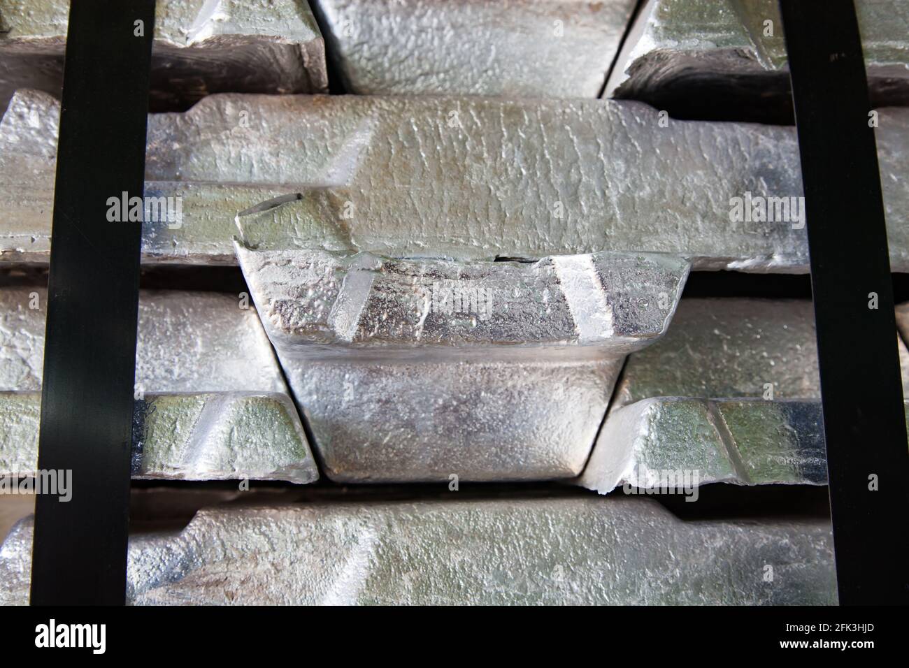 Stack of raw aluminum ingots (bars) in aluminum wire factory. Close up ...