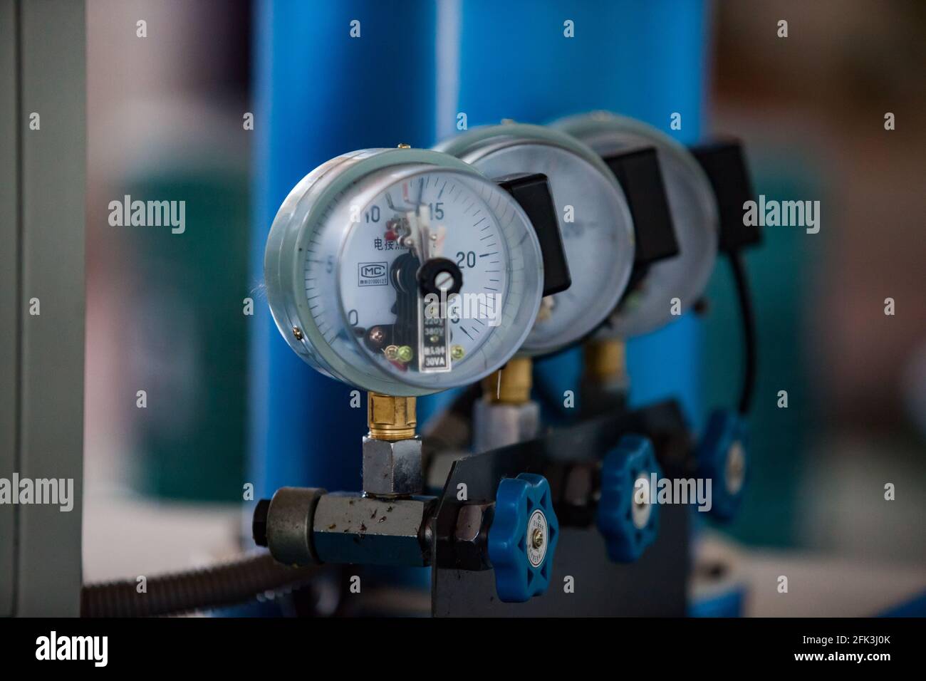 Close-up of manometer gauges and blue pipes. Low depth of field ...