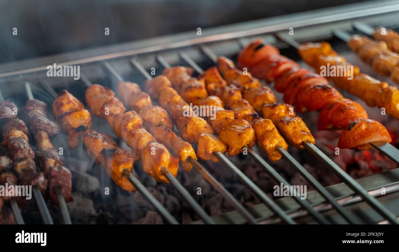 Arabic traditional food Shish taouk and tomato on the grill ...
