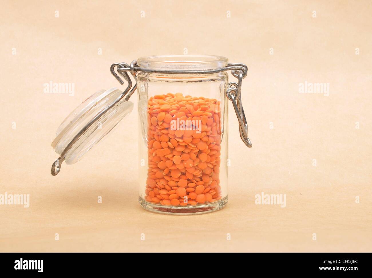 Red lentils in jar and brown background Stock Photo - Alamy