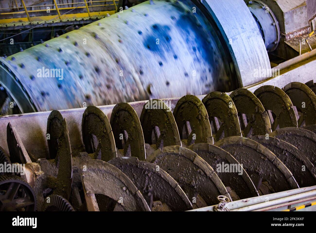 Screw conveyor close-up. Ore concentration plant. Factory ball mill on ...